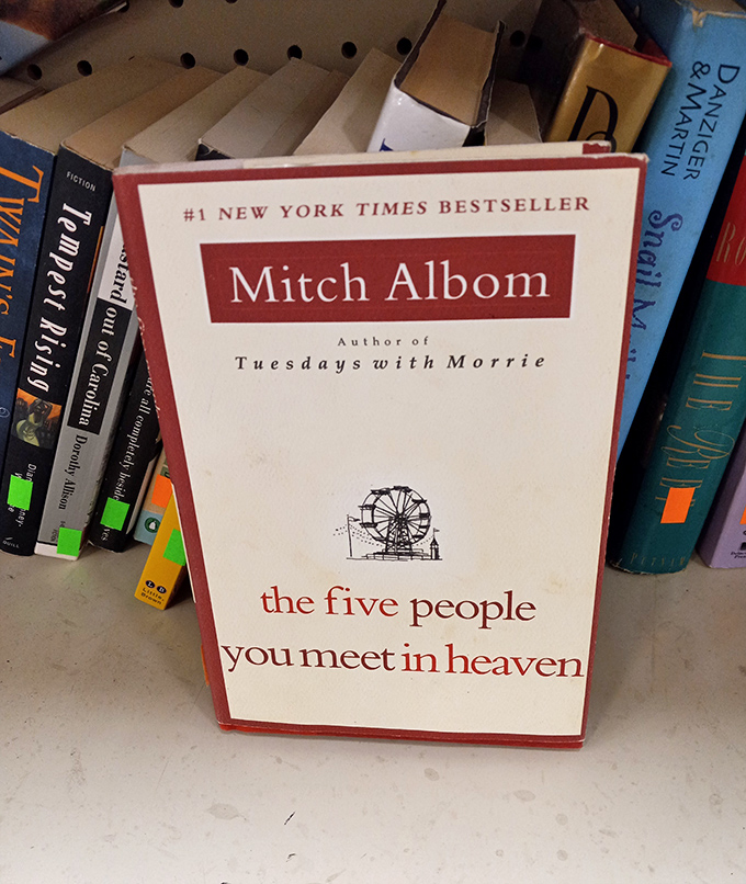 Between dusty covers and dog-eared pages, Mitch Albom's bestseller waits for its next reader. Books here are like old friends&mdash;slightly worn but full of wisdom.