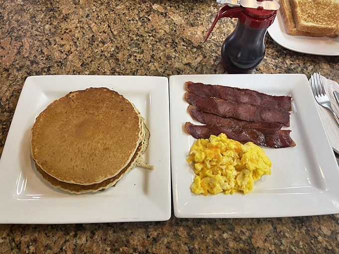Pancakes so perfectly golden they belong in Fort Knox, paired with eggs and bacon that make hitting the snooze button worth every minute.
