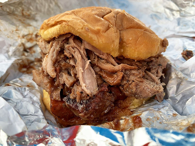 A pulled pork sandwich so generously stuffed, it's practically wearing its filling like a proud badge of honor. This isn't fast food—it's slow food served quickly.