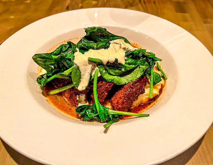 This isn't just braised meat&mdash;it's a brisket revelation, tender enough to cut with a whisper, resting on greens that have absorbed all those magnificent juices.