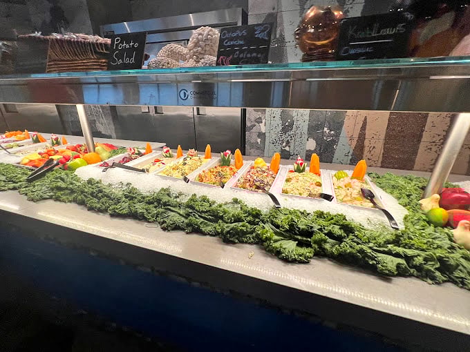 The salad bar lineup reminds us that occasionally, even in seafood paradise, vegetables deserve their moment too.
