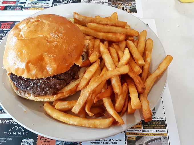 The burger arrives unadorned and confident, like a Hollywood star who doesn't need makeup &ndash; just pure, beefy perfection alongside golden fries.