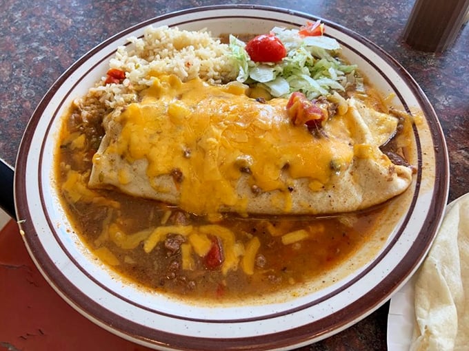 Behold the burrito—where cheese meets chile in a tortilla embrace so perfect it could bring peace to warring nations.