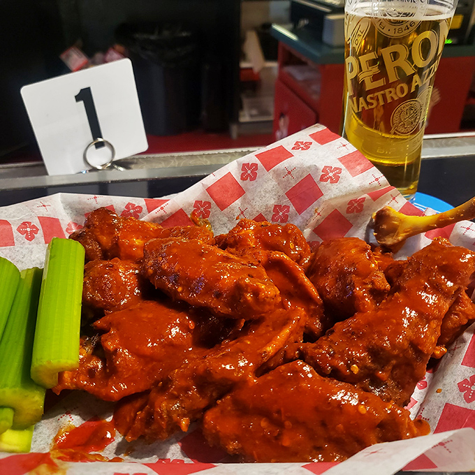 Buffalo wings so vibrant they practically glow in the dark. The celery sticks are just pretending to make this a balanced meal. 