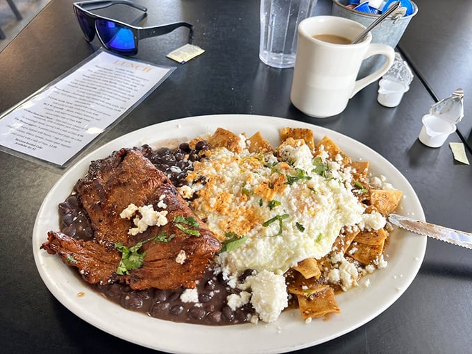 This plate is what happens when breakfast crosses borders&mdash;beans, tortilla chips, eggs, and what appears to be carne asada creating a morning fiesta.