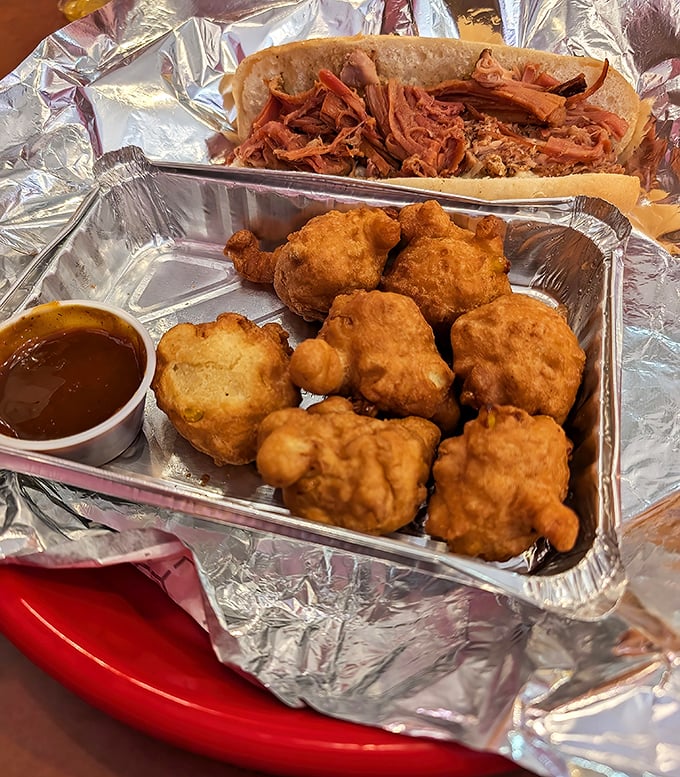 Hush puppies' sophisticated cousins have arrived. These golden-fried corn fritters achieve that mythical balance of crispy exterior and fluffy interior.