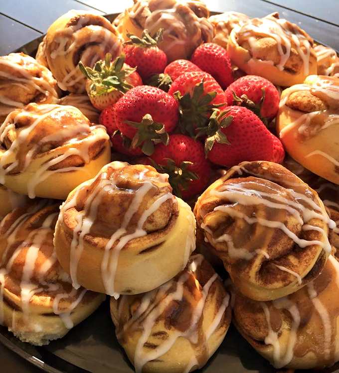 A plateful of cinnamon rolls surrounded by fresh strawberries is what I imagine angels eat when they've been particularly angelic.