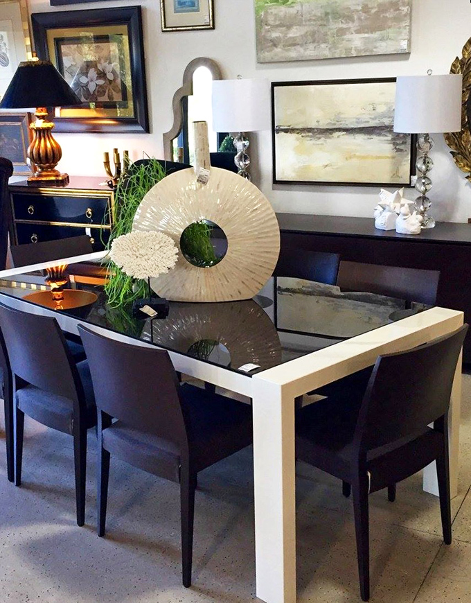 A glass dining table that somehow makes formal dinners feel less stuffy and more "let's linger over dessert and solve the world's problems."