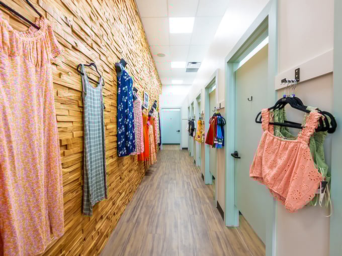 The fitting room hallway features textured wood paneling and mint-colored doors&mdash;a far cry from the fluorescent-lit closets of typical secondhand shops.