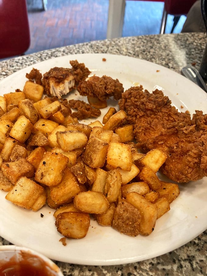 These home fries have achieved the perfect crisp-tender balance while the chicken stands by, wearing its golden crust like designer fashion.
