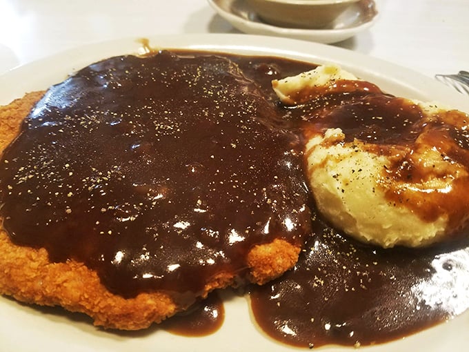 Country fried steak swimming in gravy so good you'll want to write home about it&mdash;if you weren't too busy cleaning your plate.