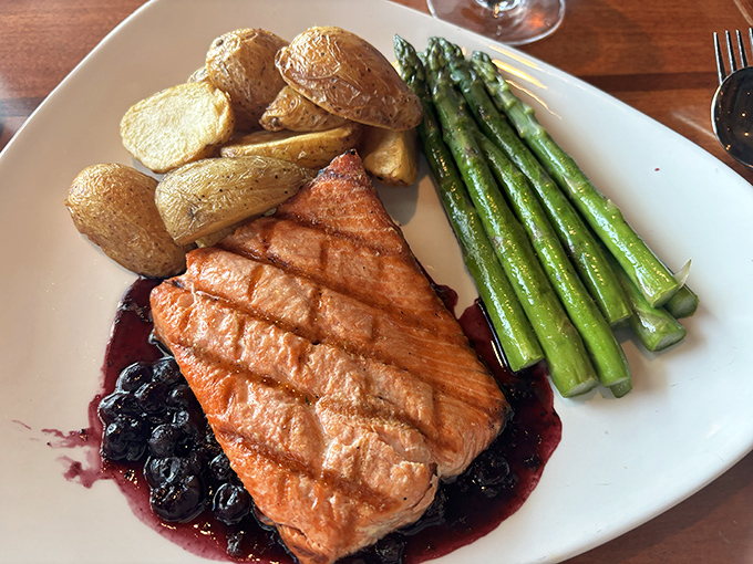 Perfectly grilled salmon on a bed of blueberry compote—Northwest cuisine that makes you understand why bears fight over this fish.