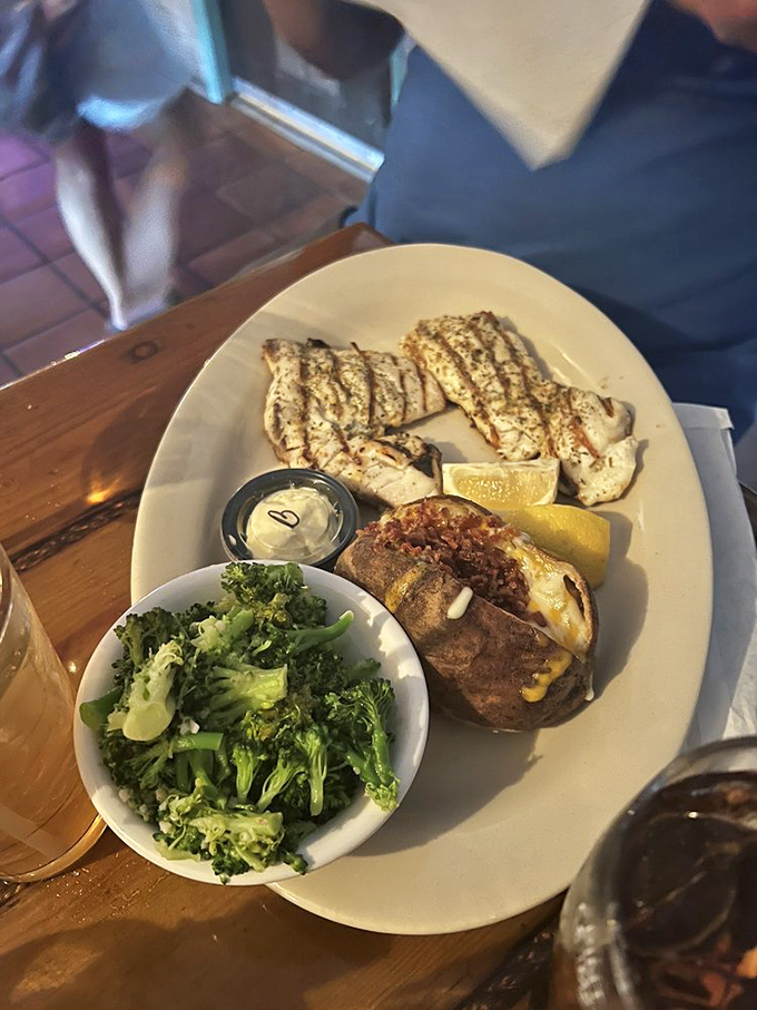 A plate that says "vacation" more clearly than your out-of-office email. Perfectly grilled fish, loaded potato, and broccoli that actually looks appetizing.