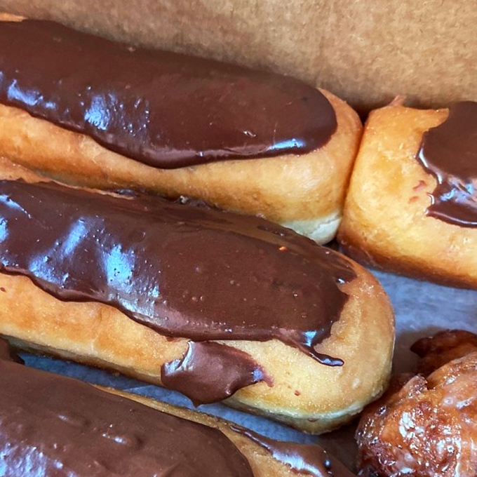 Chocolate-topped long johns lined up like soldiers in a delicious army. The glossy chocolate practically winks at you.