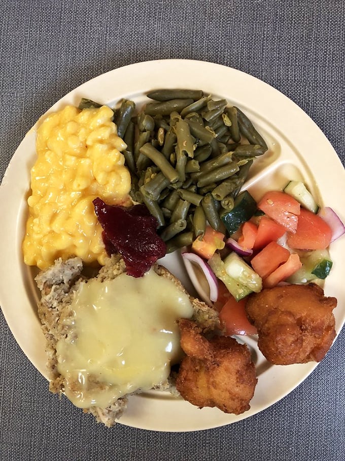 Southern plate lunch perfection&mdash;meatloaf, mac and cheese, green beans, and hushpuppies. This isn't just food; it's a warm hug on a plate.
