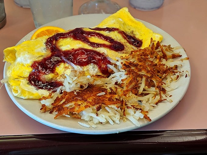 Behold the omelet that launched a thousand food comas. That crispy hash brown edge deserves its own fan club.