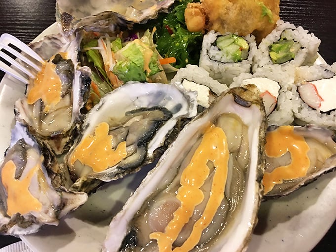Oysters topped with vibrant sauce alongside delicate sushi rolls. It's the kind of plate that makes you feel sophisticated even while wearing your "buffet strategy" face.