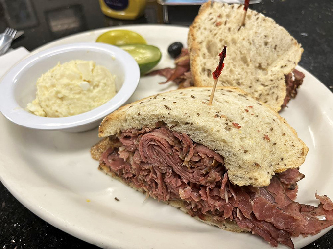 A proper pastrami sandwich should require both hands and at least three napkins. This mountain of thinly-sliced perfection passes the test with flying colors.