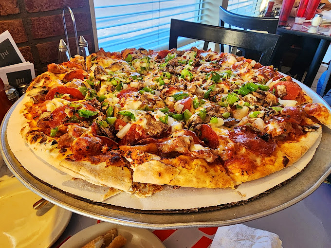 This isn't just pizza&mdash;it's a family reunion of perfect toppings. The crust has achieved that golden-brown perfection that makes time stand still.