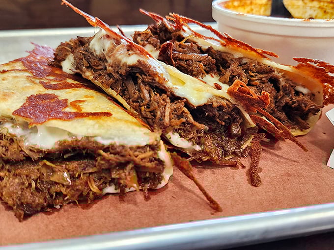 Quesabirria that bridges cultures: tender beef tucked into crispy grilled cheese that makes you wonder why all sandwiches aren't this brilliant.