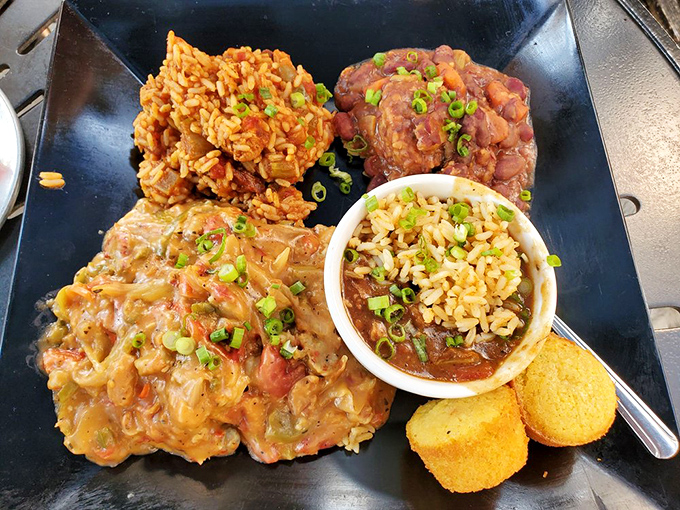 The Cajun trinity of jambalaya, red beans, and étouffée on one plate – like finding the Holy Grail of Southern comfort on a St. Louis afternoon.