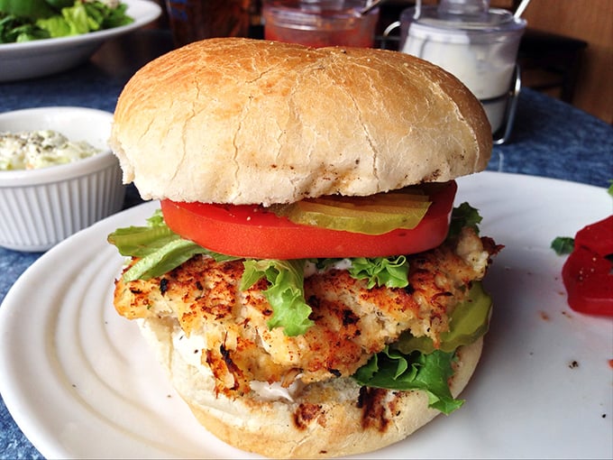 This isn't just a crab cake sandwich&mdash;it's architecture. The perfect stack of seafood, fresh vegetables, and bread that somehow defies the laws of sandwich physics.