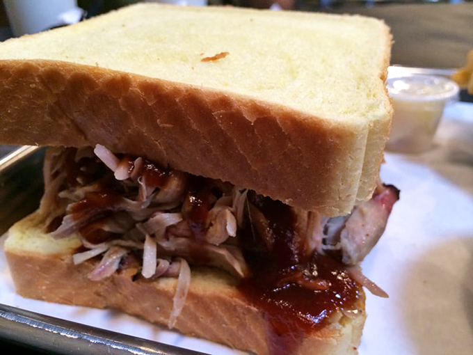 The pulled pork sandwich – where smoke-kissed meat meets bread in a relationship so perfect it should have its own romantic comedy.