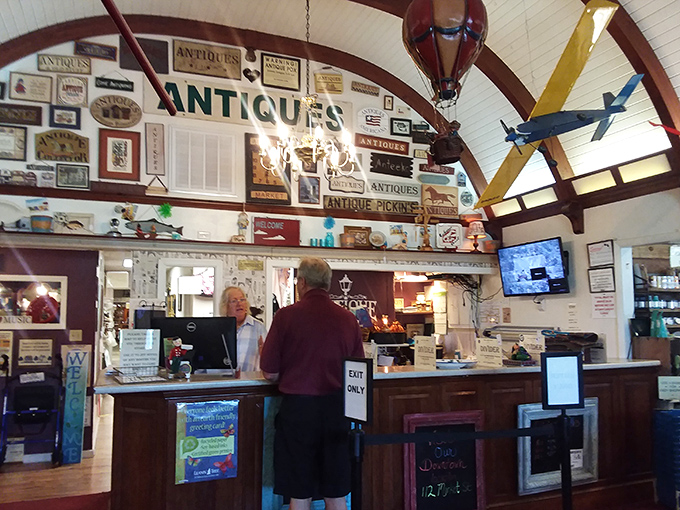 The check-out counter&mdash;where dreams meet reality and wallets open willingly. Note the vintage signs and model hot air balloon hanging from those gorgeous wooden beams.