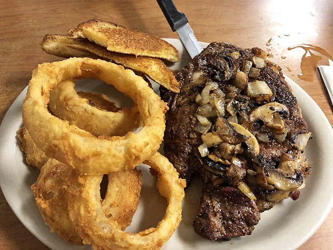 A steak that needs no introduction, only appreciation. Those golden onion rings aren't sidekicks&mdash;they're co-stars in this plate of pure satisfaction.