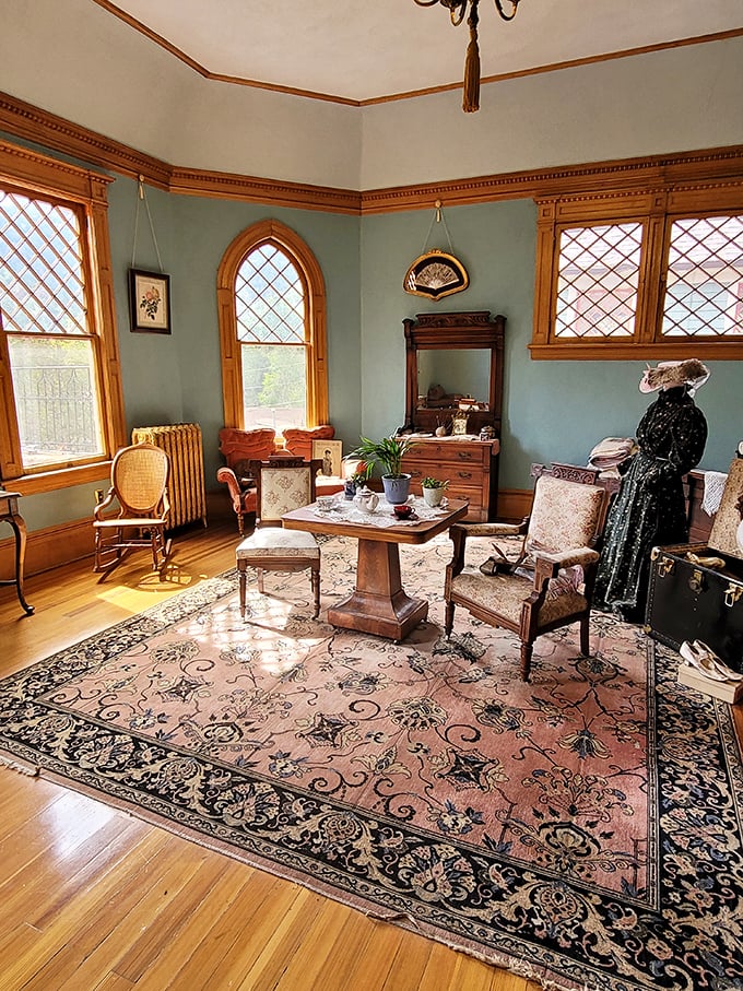 This elegant sitting room, with its soft mint walls and diamond-paned windows, practically begs you to gossip about the latest society scandal.
