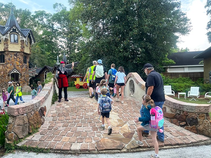 The magic is meant to be shared! Visitors cross the stone bridge, each step taking them further from ordinary life into storybook wonder.