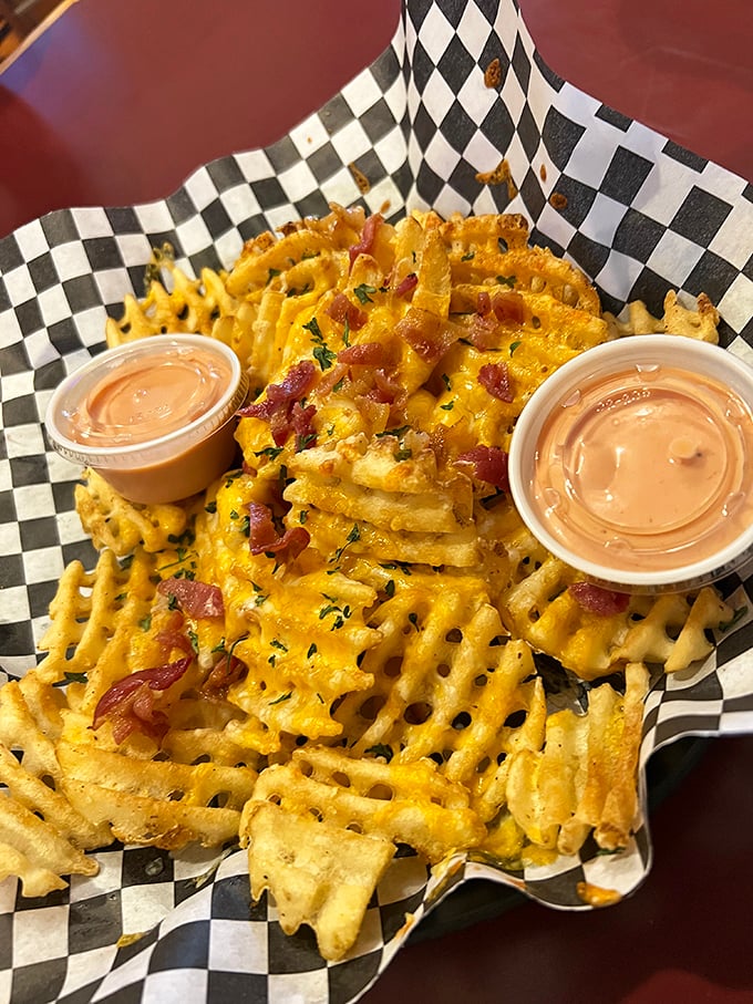 Waffle fries that went to finishing school&mdash;dressed up with cheese and bacon like they're heading to the potato prom.