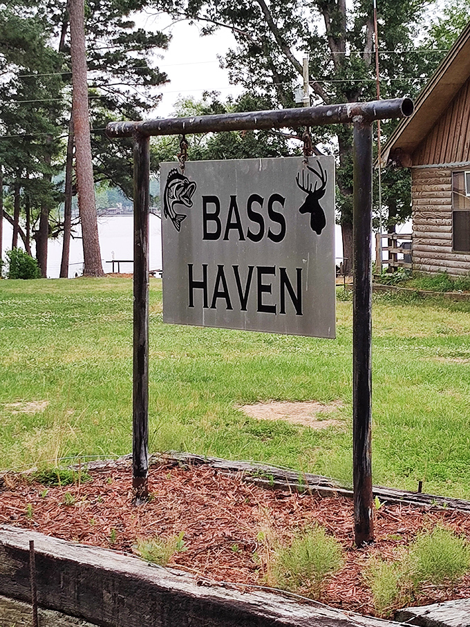 Bass Haven's rustic sign stands sentinel by the lake, promising fishermen and food-lovers alike a taste of authentic Arkansas.