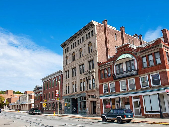 Fitchburg's commanding brick buildings create a striking downtown silhouette against a pristine blue Massachusetts sky.