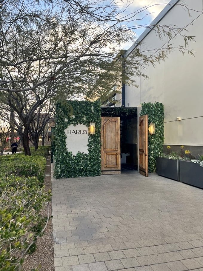 Harlo's ivy-covered entrance with rustic wooden doors feels like discovering a secret garden of carnivorous delights.