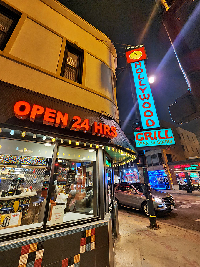Hollywood Grill's neon sign lights up the night like a beacon for the breakfast-deprived. Where 3 AM pancake dreams come true!