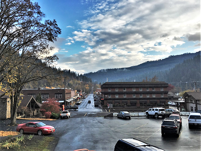 Orofino's historic downtown buildings stand against a backdrop of forested hills, offering affordable living in nature's embrace.