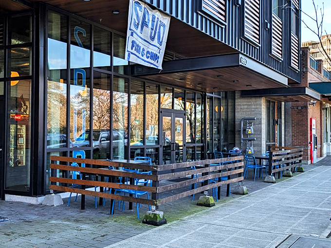 Spud's simple storefront and wooden patio promise no-frills fish perfection. Blue chairs await crispy cod enthusiasts!