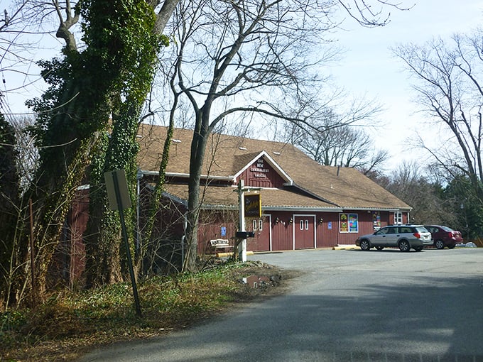 The Candlelight Theatre's rustic barn exterior hides a world of dinner and drama waiting to unfold inside.