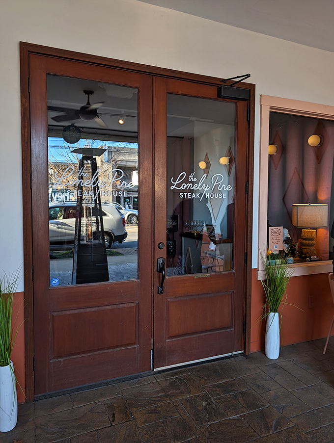 The Lonely Pine's elegant wooden doors&mdash;where mid-century modern meets mouthwatering meat.