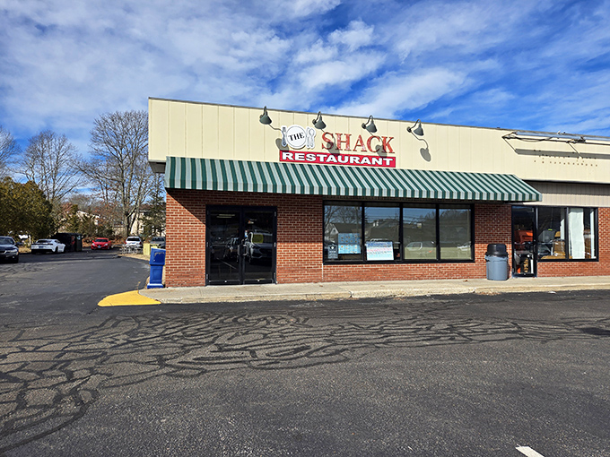 The Shack's humble exterior and green-striped awning hide a treasure trove of breakfast delights within. 
