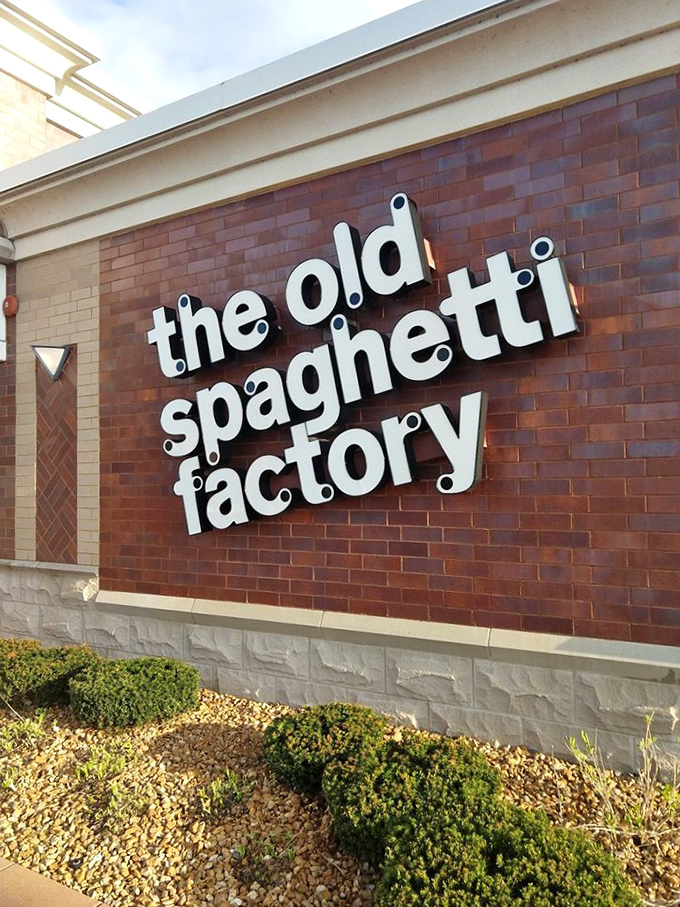 The Old Spaghetti Factory's distinguished brick facade houses pasta paradise. Behind those walls awaits a vintage trolley car dining experience.