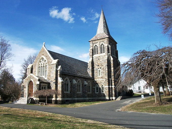 Historic stone walls and a striking pointed spire define your visit to Washington, offering a peaceful glimpse into local heritage.