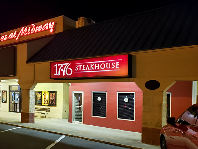 The illuminated sign of 1776 Steakhouse glows like a beacon in the night, calling all patriots of proper beef preparation.
