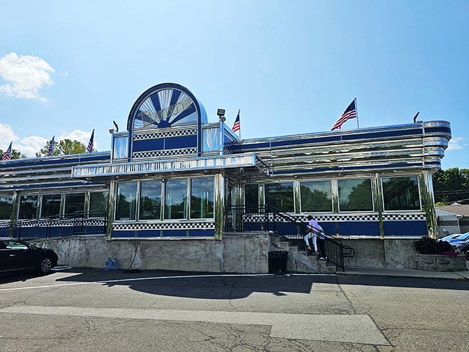 Blue Colony Diner side view: "Sunshine bounces off polished stainless steel, creating a breakfast beacon visible from space&mdash;or at least from the highway."
