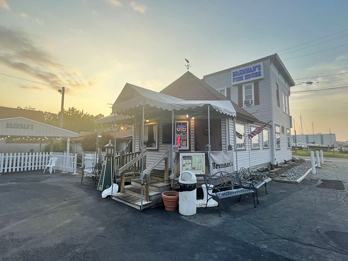 Brennan's Fish House: Sunset casts a golden glow on this seafood institution. The American flag and welcoming porch promise heartland hospitality with coastal flavors.