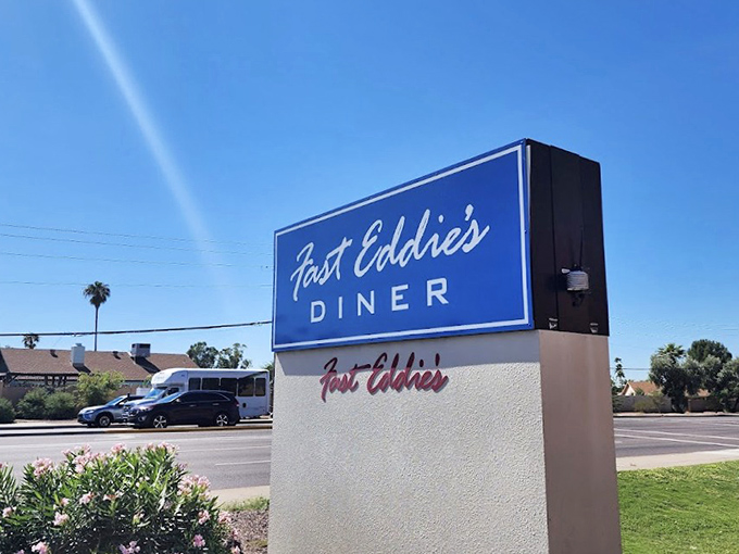 That blue sign promises salvation to empty stomachs across Phoenix – and Fast Eddie's delivers every time.