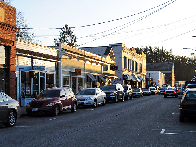 La Conner&rsquo;s streets glow with evening light &ndash; a golden hour haven where shops and cafes beckon.