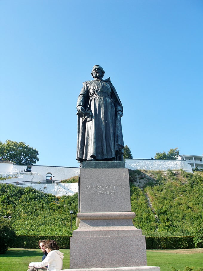 The Marquette statue stands tall, overlooking the straits like a historical figure who's seen it all but is still impressed by the view.
