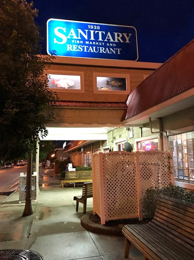 Sanitary Fish Market: By day, a cheerful seafood haven&mdash;by night, a glowing beacon for hungry souls seeking hushpuppy salvation.